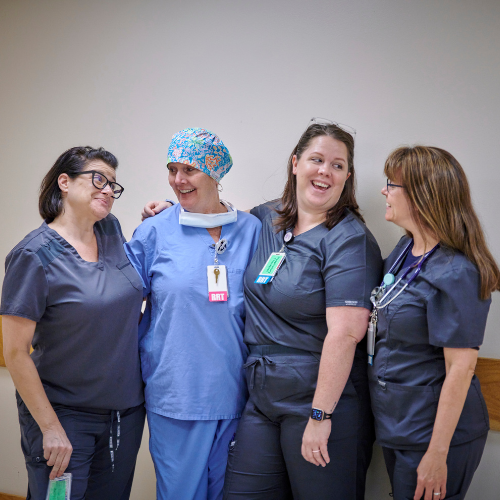 Group of respiratory therapists smiling in the hospital hallway